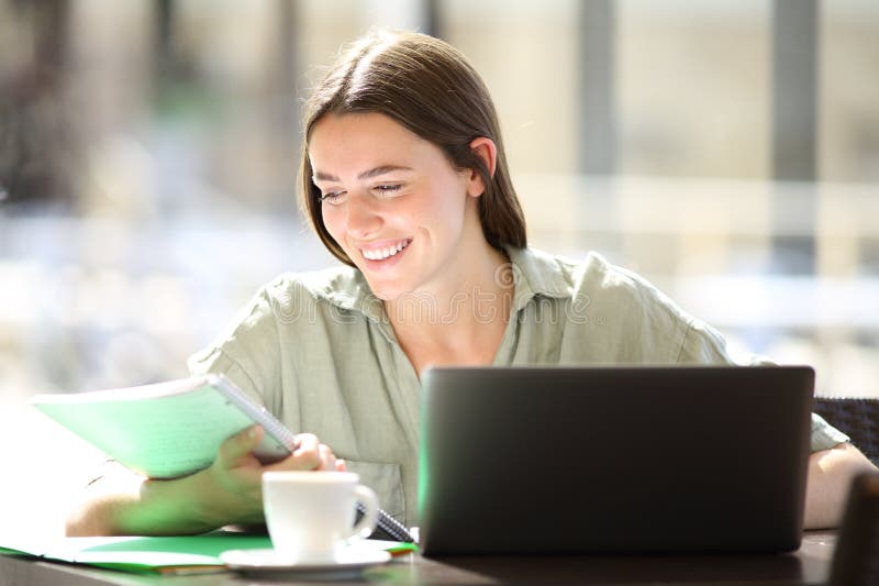 Happy Student in a Bar Reading Notes Using Laptop Stock Image - Image ...