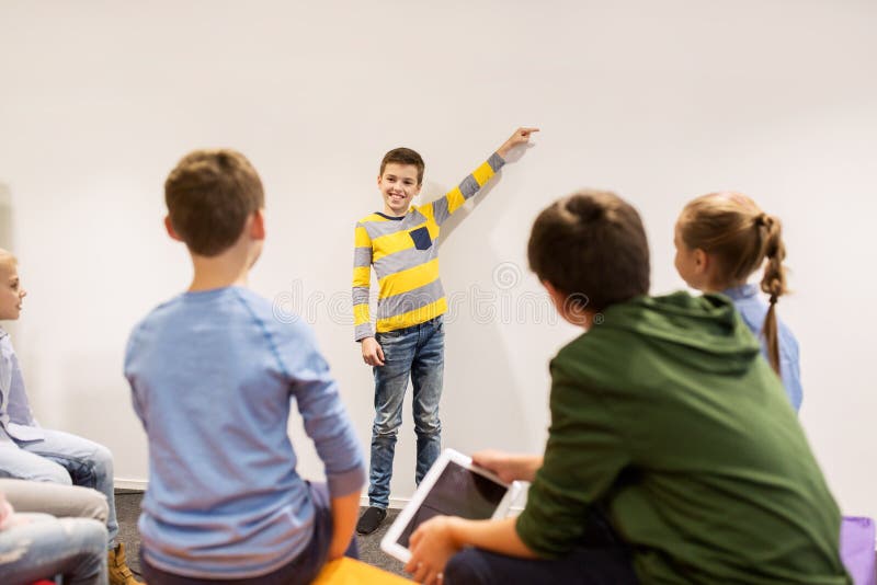 Happy Student Boy Showing Something at White Wall Stock Photo - Image ...