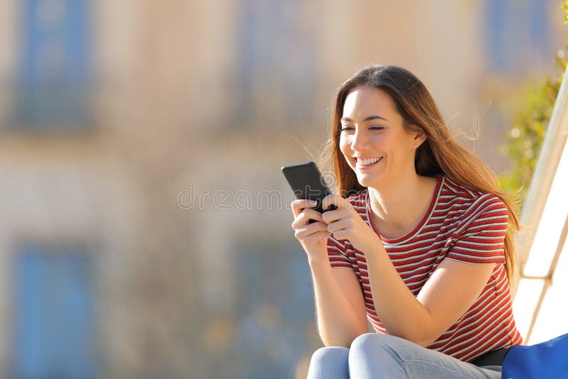 Happy Student Checking Mobile Phone in a Campus Stock Image - Image of ...