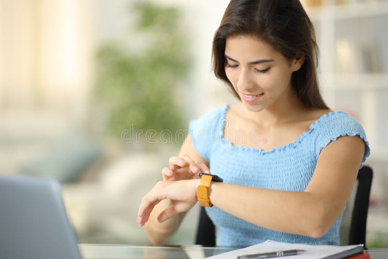 Happy Student Checking Smartwatch in a House Interior Stock Image ...
