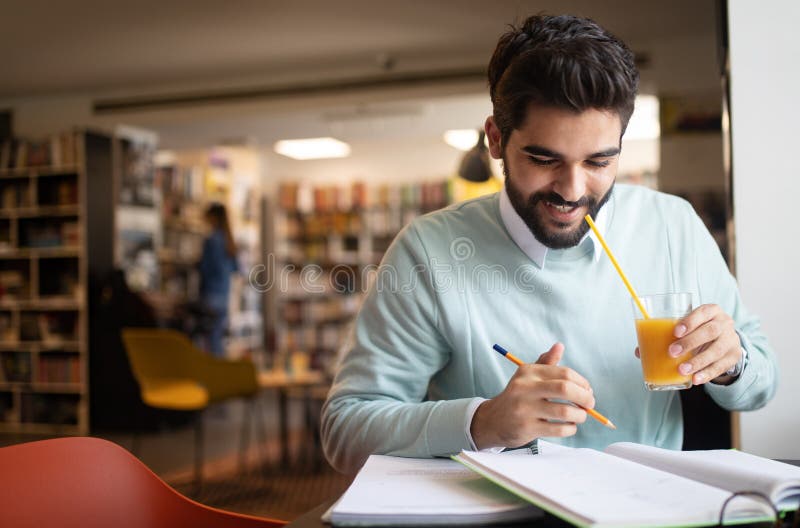 Happy Student Preparing Exam and Learning Lessons in College Library ...