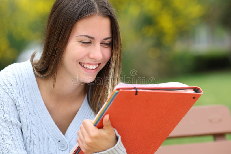 Happy Student Reading Notes in a Park Stock Photo - Image of alone ...