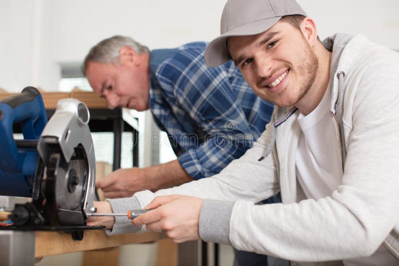Happy Student and Teacher in Carpentry Class Using Circular Saw Stock ...