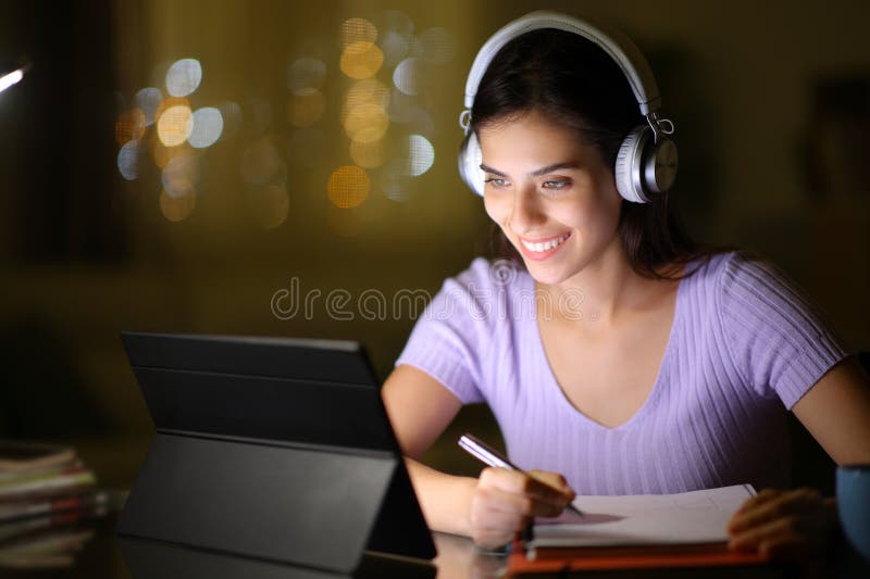 Happy Student Using Tablet and Headphone in the Night Stock Image ...