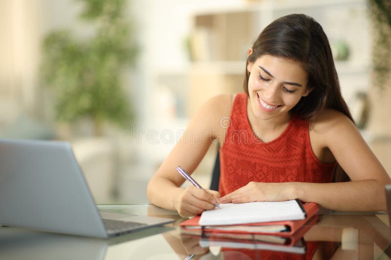 Happy Student Writing in a Notebook at Home Stock Photo - Image of ...