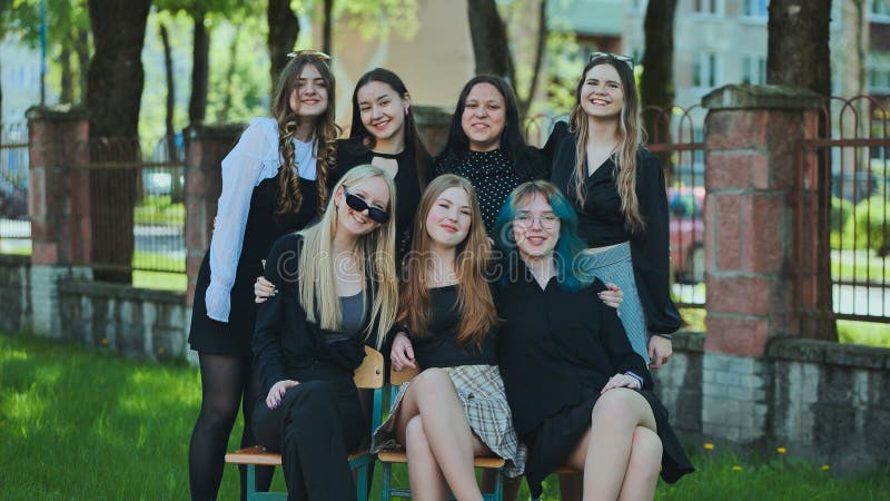 Happy Students Gathering on a Bench in the Schoolyard, Enjoying Their ...