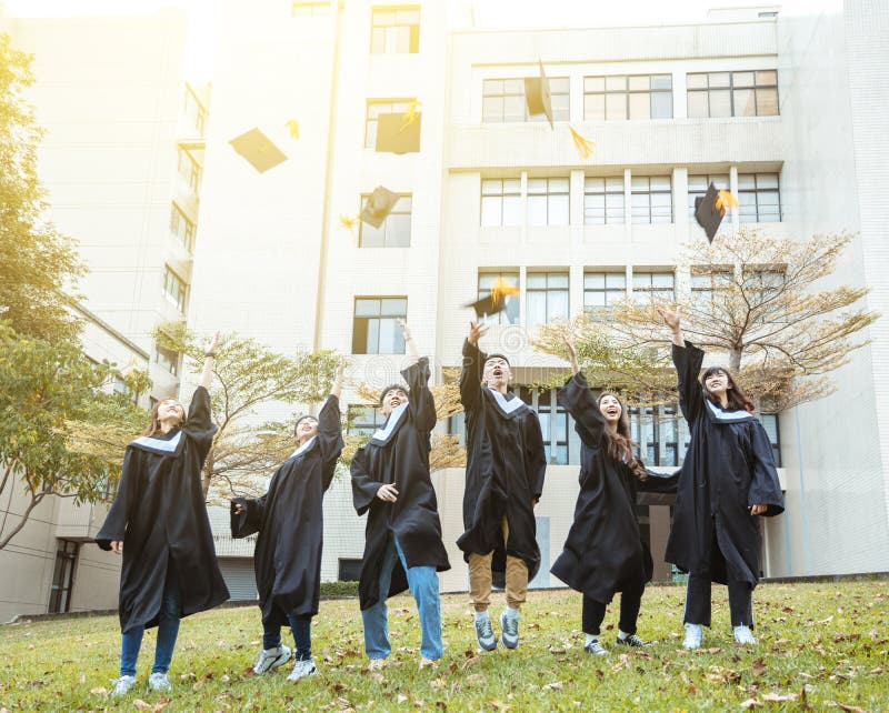 Happy Students in Graduation Gowns Celebrating and Jumping in ...
