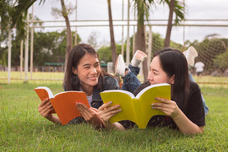 Happy Students is Reading Book on Lawn Stock Photo - Image of lawn ...