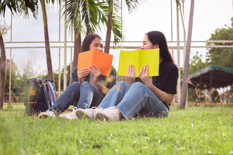 Happy Students is Reading Book on Lawn Stock Photo - Image of lying ...