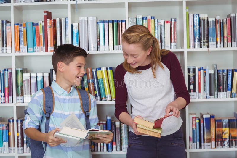 Happy Students Reading Books in Library Stock Photo - Image of child ...