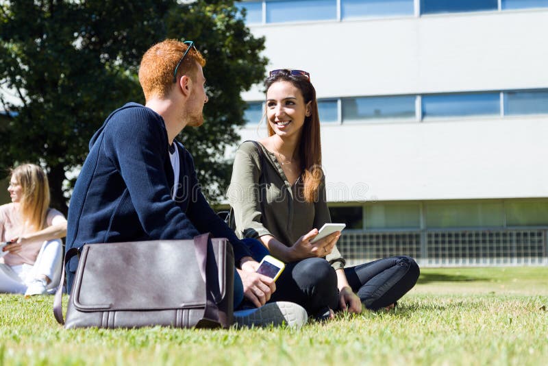 Happy Students Sitting Outside on Campus at the University. Stock Photo ...