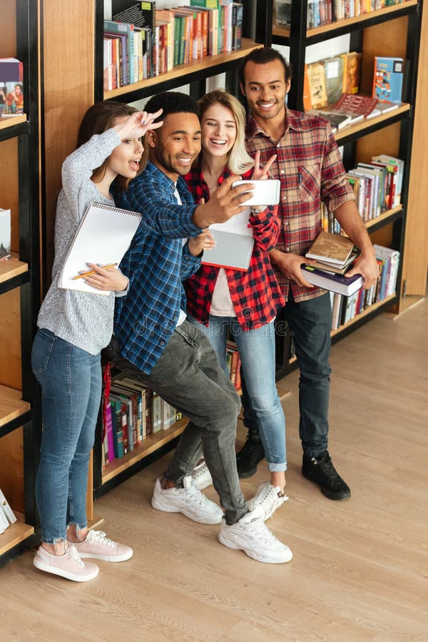 Happy Students Standing in Library while Make Selfie Stock Photo ...