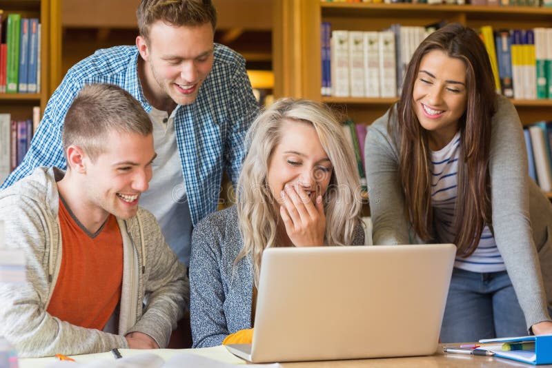 Happy Students Using Laptop at Desk in Library Stock Image - Image of ...