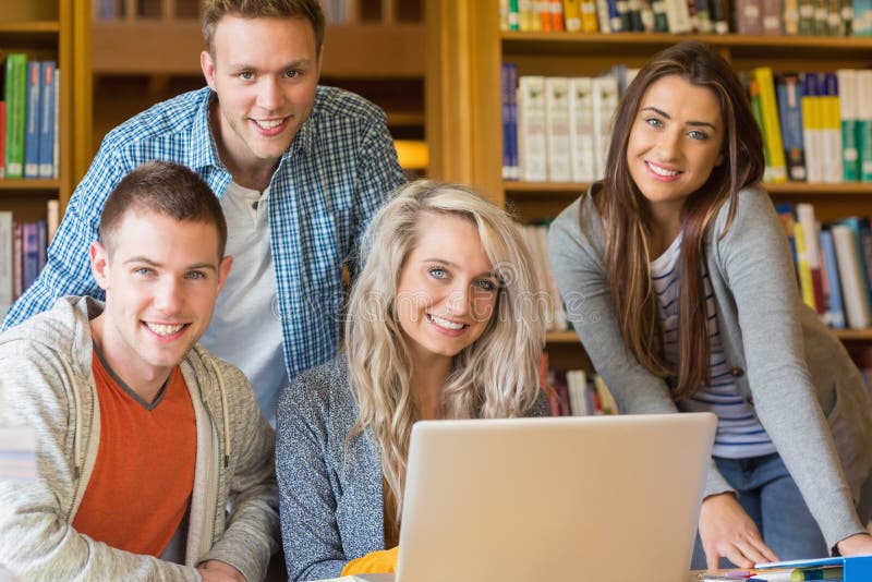Happy Students Using Laptop at Desk in Library Stock Image - Image of ...