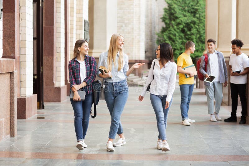 Happy Students Walking in University Hall during Break Stock Photo ...