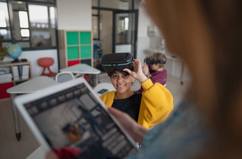 Happy Students Wearing Virtual Reality Goggles at School in Computer ...