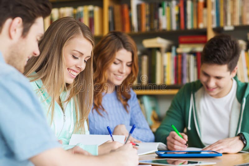 Happy Students Writing To Notebooks in Library Stock Photo - Image of ...