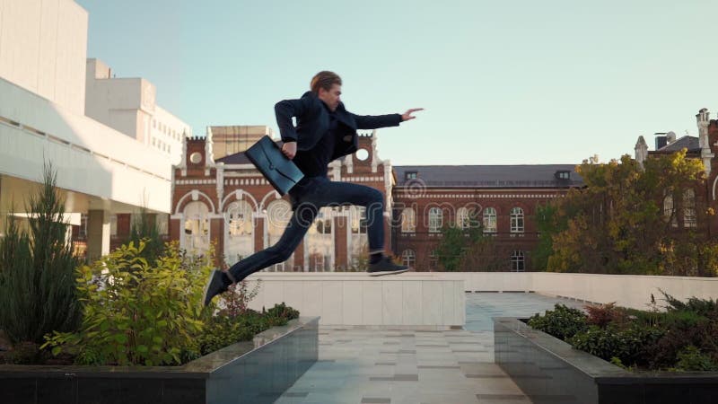 Happy Successful Business Man with Folder Documents Jumping Over an ...