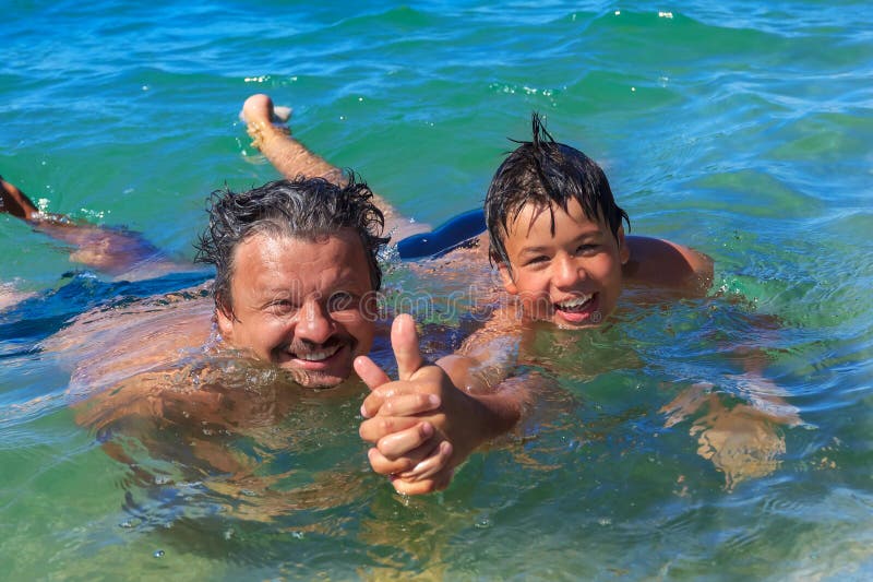 Happy Swimmers Dad and Son in the Sea Stock Photo - Image of smile ...