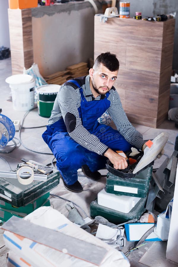 Worker is Choosing Tools in Suitcase for Work at the Object. Stock ...