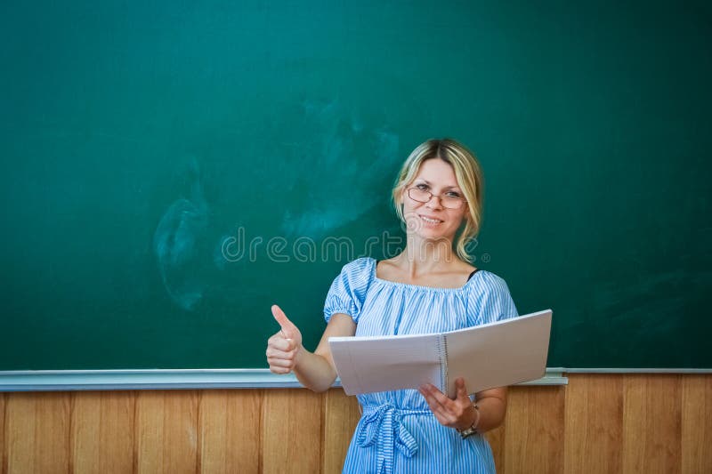 A Happy Teacher at the Blackboard in the Classroom Room Back To Class ...