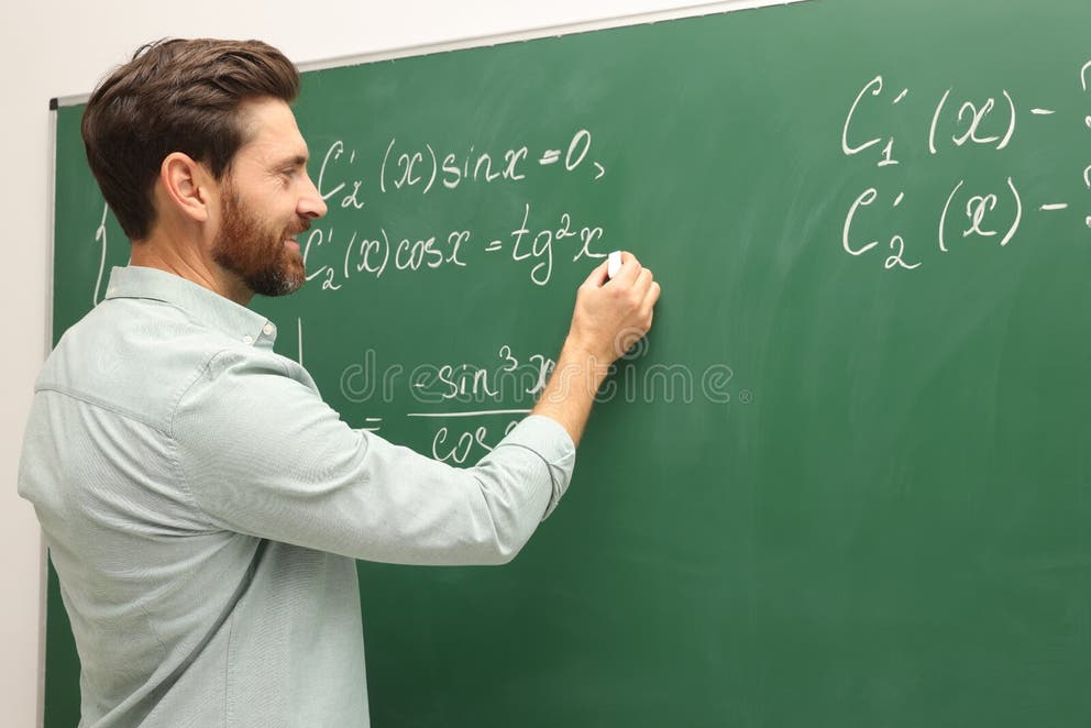 Happy Teacher Explaining Mathematics at Chalkboard in Classroom Stock ...