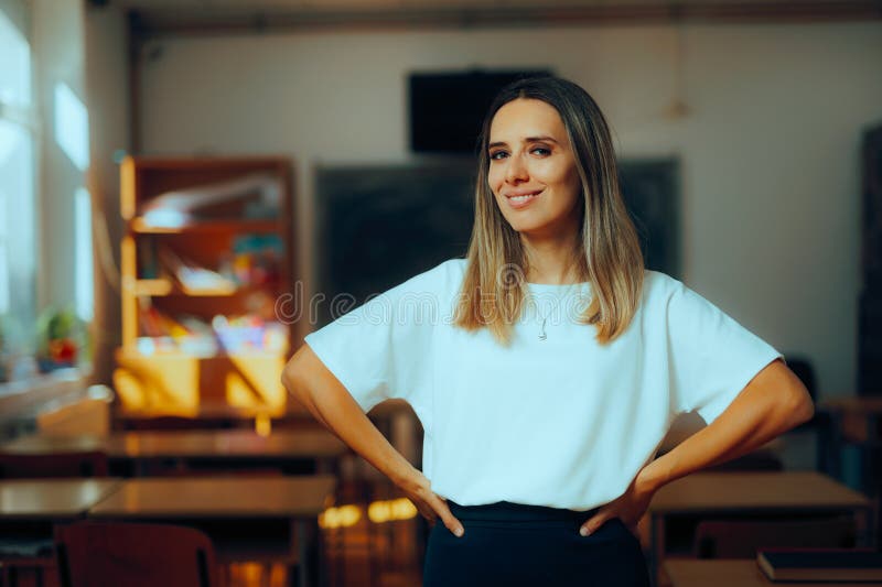 Happy Teacher Standing in a Classroom during Break Session Stock Photo ...