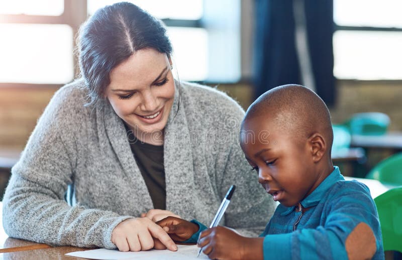 Happy Teacher, Woman and Help Child Writing in Notebook for Education ...