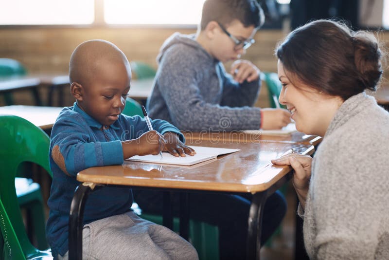 Happy Teacher, Woman and Help Kid Writing in Notebook for Education ...