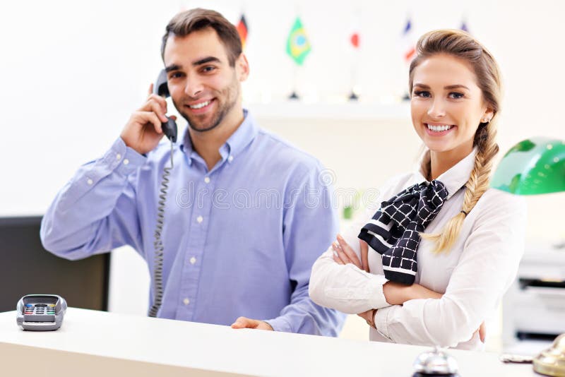 Happy Team of Hotel Receptionists Stock Image - Image of desk, lobby ...