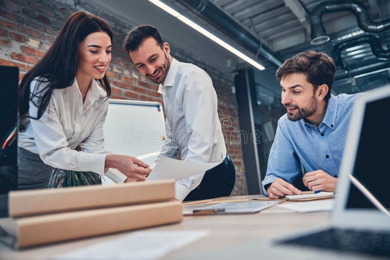 Happy Teammates Talking and Sitting in the Office Stock Image - Image ...