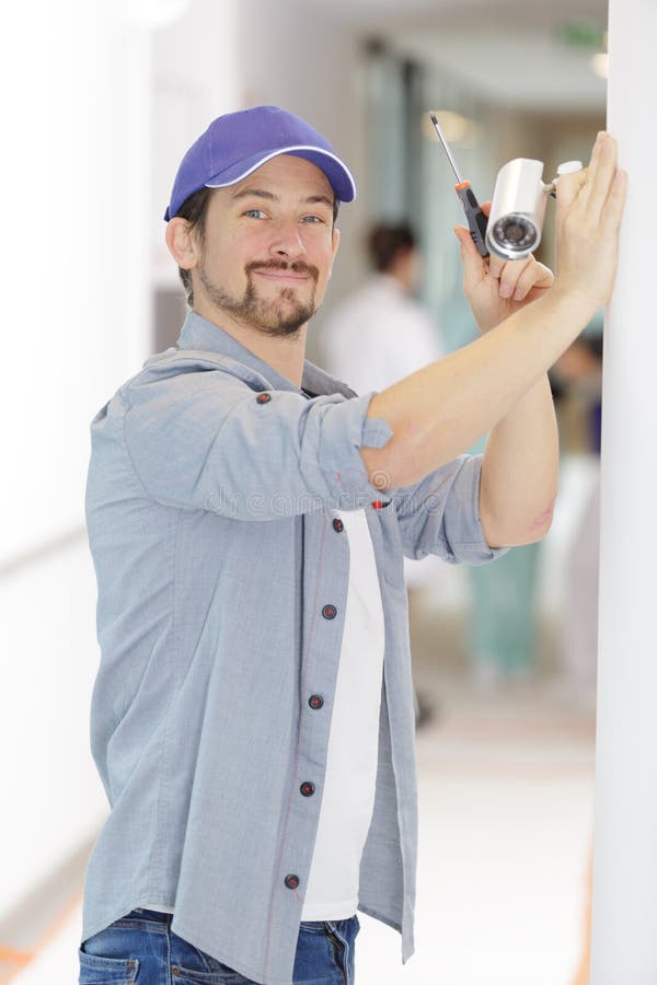 Happy Technician Adjusting Cctv Camera on Wall Stock Photo - Image of ...