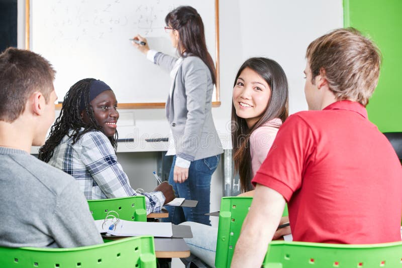 Happy teenagers in class stock photo. Image of student - 64498778