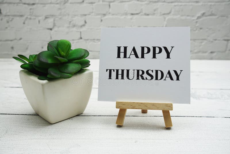 Happy Thursday Text on Wooden Easel Standing on White Brick Wall and ...
