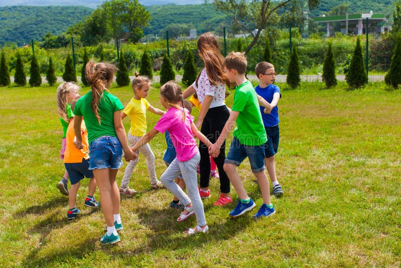 Tutor with Kids Outdoor Dancing in the Circle Stock Image - Image of ...