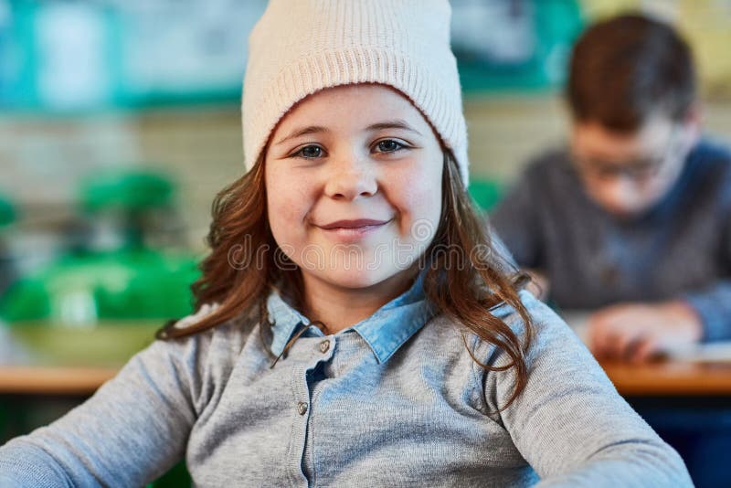 Happy To Be in Class. an Elementary School Girl in the Classroom. Stock ...