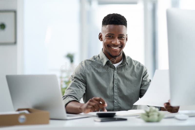 Happy To Be in the Office. a Young Businessman Working on a Computer in ...