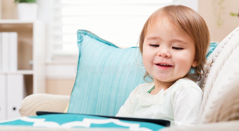 Happy Toddler Girl Watching Her Tablet Computer Stock Photo - Image of ...