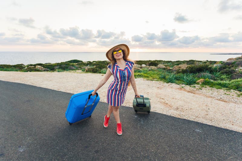 Happy Traveler Woman With Suitcase On The Road And Laughs Concept Of