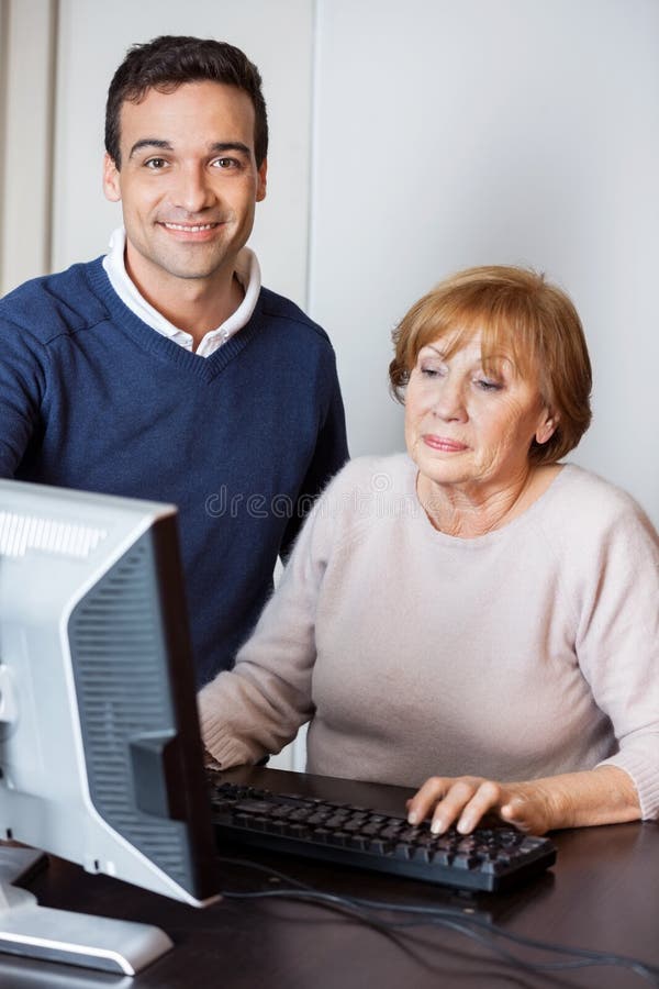 Tutor Assisting Student Using Computer in Lab Stock Image - Image of ... Tutor Assisting Student Using Computer in Lab Stock Image - Image of ...