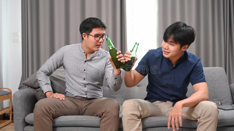 Happy Two Man Drinking Beer while Sitting on Sofa. Stock Image - Image ...