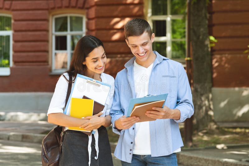 Happy University Friends Standing Outdoors in Campus, Checking Test ...