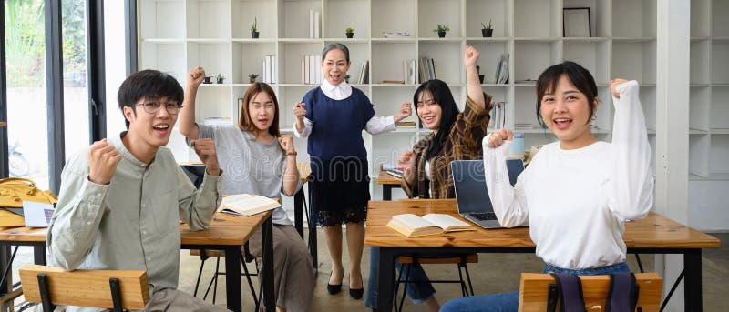 Happy University Students and Mature Professor Celebrating Success in ...