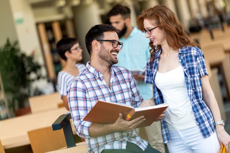 Happy University Students Studying with Books in Library. Group of ...