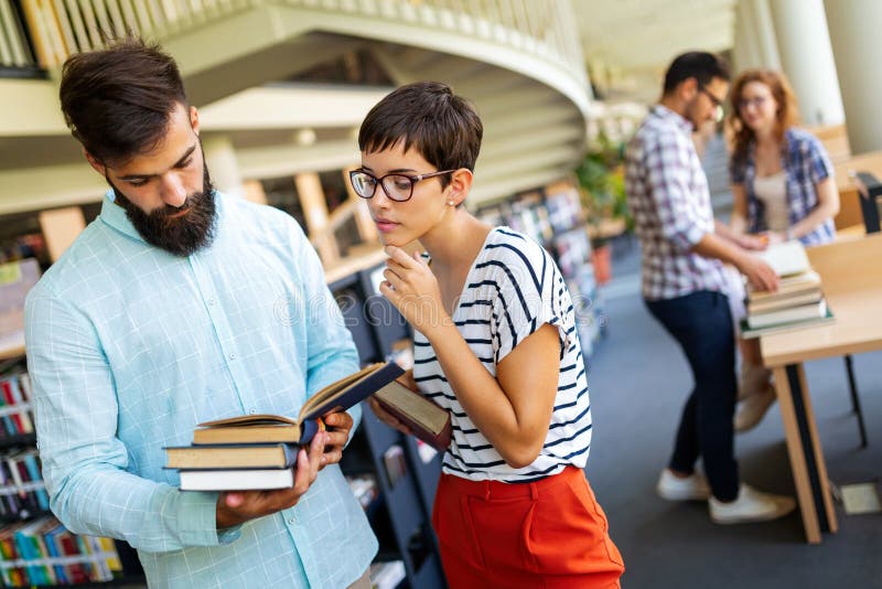 Happy University Students Studying with Books in Library. Group of ...