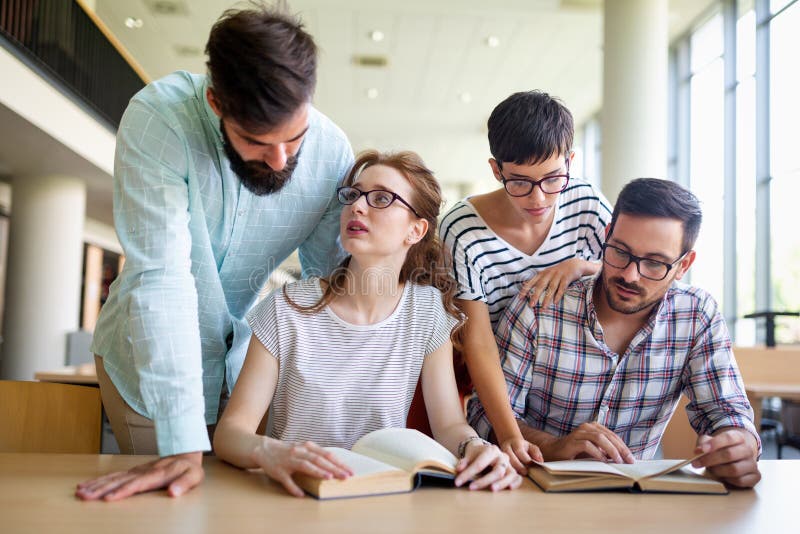 Happy University Students Studying with Books in Library. Group of ... Happy University Students Studying with Books in Library. Group of ...
