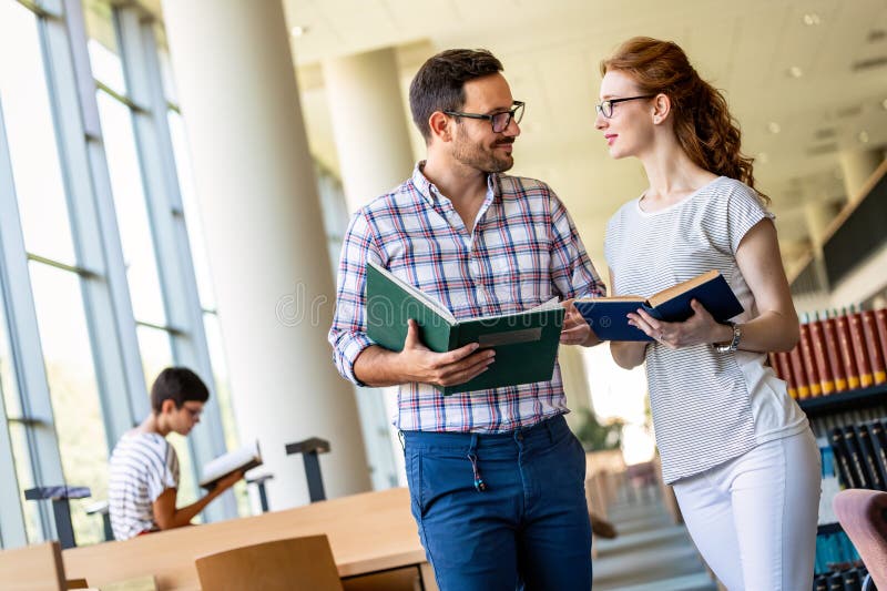 Happy University Students Studying with Books in Library. Group of ...