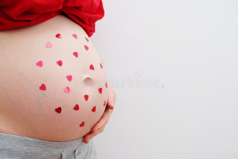 Happy Valentines Day A Pregnant Woman With Heart Shaped Sequins On Her