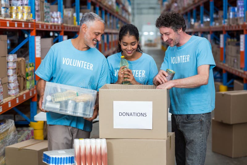 Happy Volunteers are Looking Inside a Donations Box Stock Photo - Image ...
