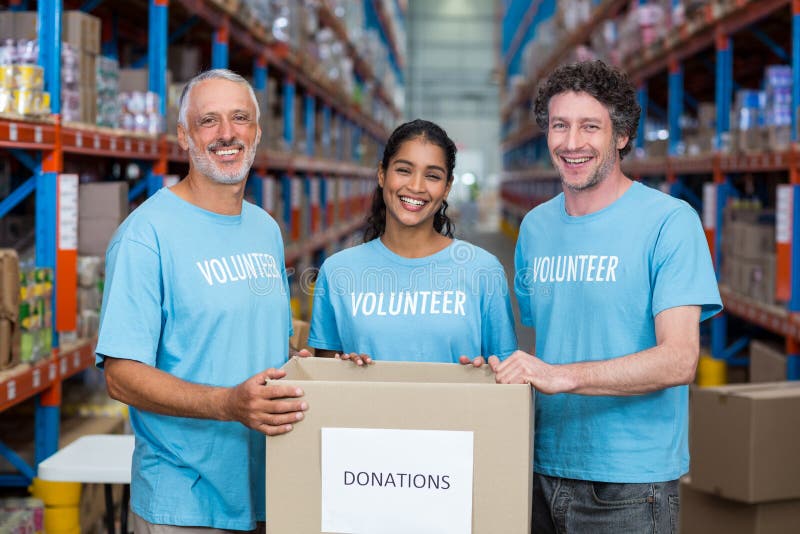 Happy Volunteers are Smiling and Posing with a Donations Box Stock ...